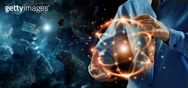 Abstract science, hands holding atomic particle, nuclear energy imagery ...