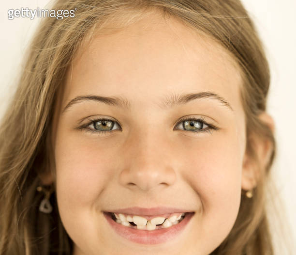 Portrait Of A Cute Girl With Blue Eyes And A Beautiful Smile