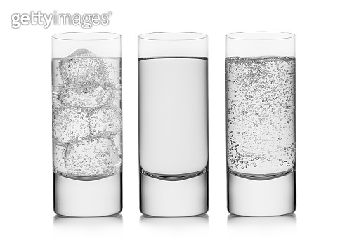 Highball glasses with sparkling and still mineral water drink on white background. With ice ...