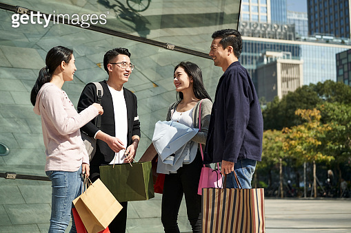 group of young asian people talking chatting conversing during shopping ...