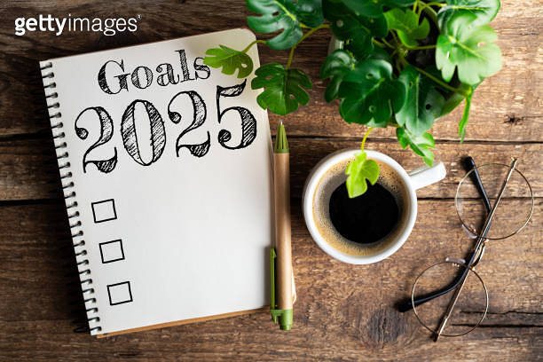 New year goals 2025 on desk. 2025 resolutions list with notebook ...