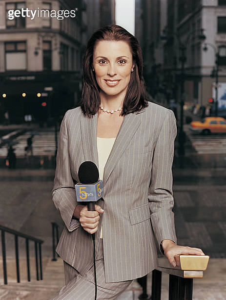Portrait of a News Reporter Standing on Steps in the City and Holding a ...