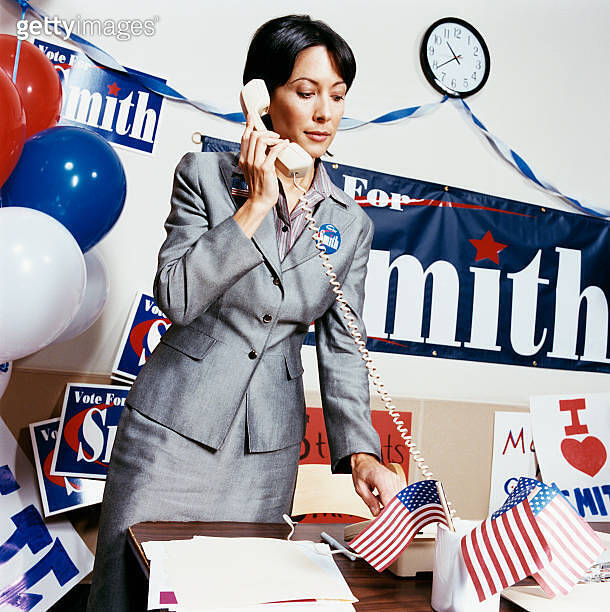 Woman Using a Telephone in an Election Campaign Office 이미지 (dv1673035 ...