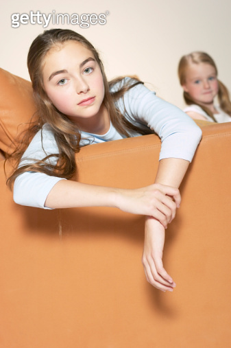 Portrait of girl leaning over side of couch 이미지 (77639847) - 게티이미지뱅크