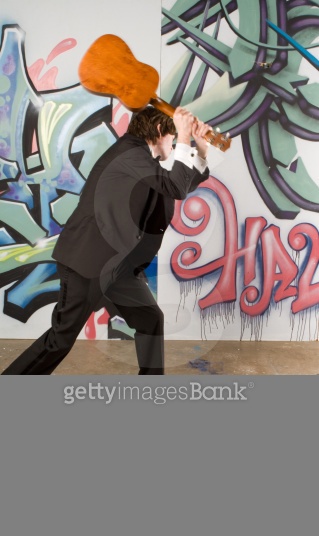 Man in Tux Smashing Ukulele or Small Guitar 이미지 (140478945) - 게티이미지뱅크