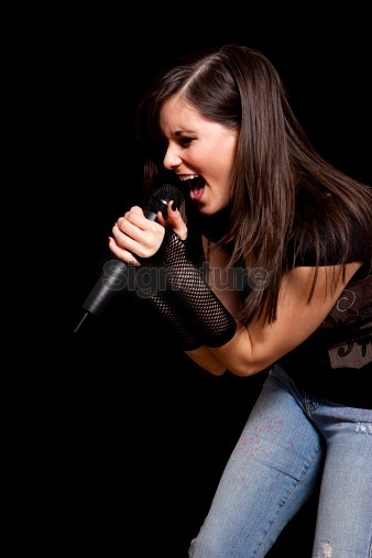 Rocker Girl Singing into Microphone on Black Background 이미지 (182673124 ...
