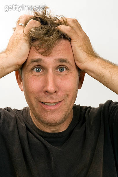 Man with hands on his head making a funny face. 이미지 (115749518) - 게티이미지뱅크