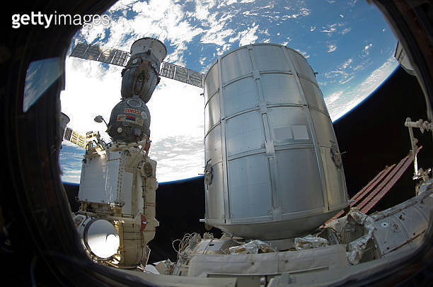 The Permanent Multipurpose Module and a docked Russian Soyuz spacecraft ...