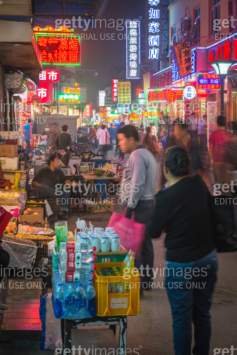 Beijing neon lights illuminating crowded hutong alley night market ...