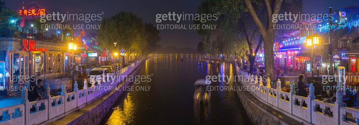 Beijing colourful bars restaurants illuminated on Houhai Lake panorama ...