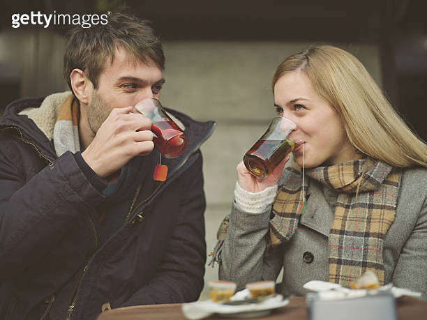two people having tea outside of a cafe 이미지 (460213019) - 게티이미지뱅크