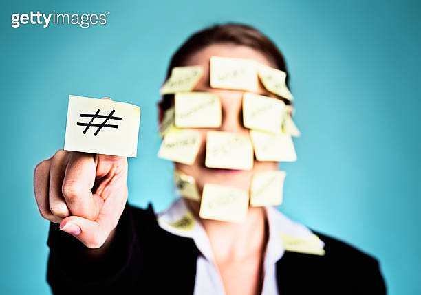 Woman covered in sticky-label reminders holds up # symbol 이미지 ...