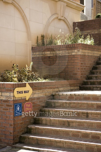 Sign reading ‘this way’ on steps 이미지 (a4002491) - 게티이미지뱅크