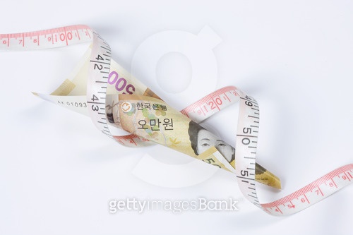 Curled Korean currency with measuring tape 이미지 (a4002920) - 게티이미지뱅크