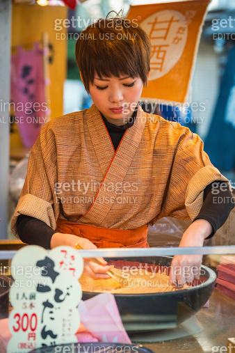 Tokyo woman preparing food Nakamise-dori market Senso-ji temple Asakusa ...