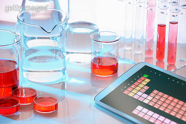 Modern science laboratory, glass chemistry equipment, tablet showing ...