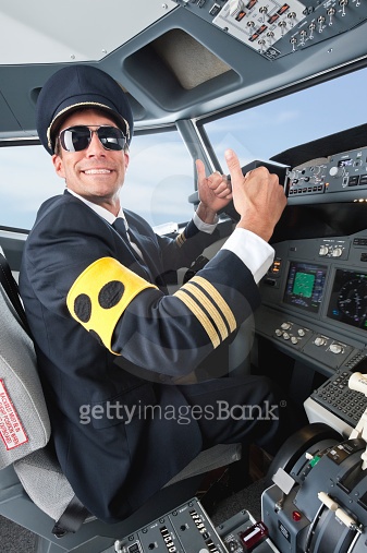 Senior flight captain with thumbs up in airplane cockpit (528955819 ...