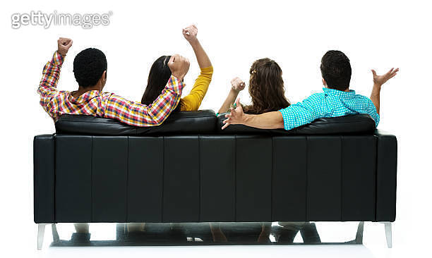 Rear view of four people sitting on couch & cheering (505442009) - 게티이미지뱅크