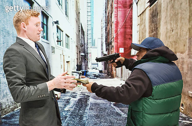 One guy with gun robbing man in the suit 이미지 (526086195) - 게티이미지뱅크