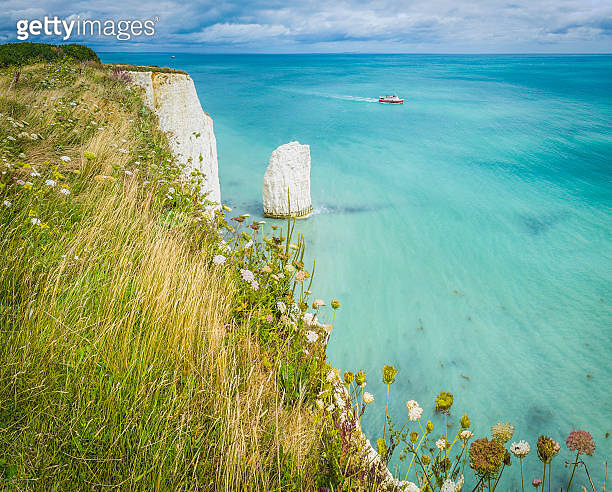 Blue ocean boat white cliffs sea stacks Jurassic Coast Dorset ...