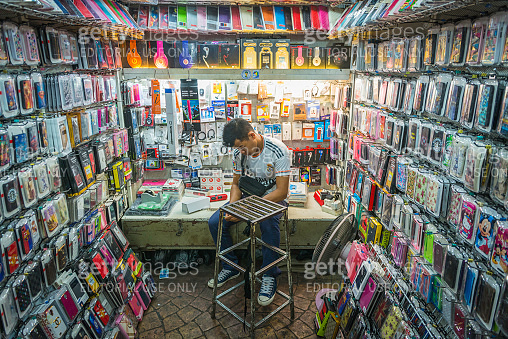Cell phone accessory vendor in market stall Kuala Lumpur Malaysia 이미지 ...