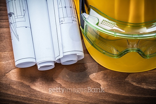 Goggles blueprint rolls and hard hat on brown wood board 이미지 (486011016 ...