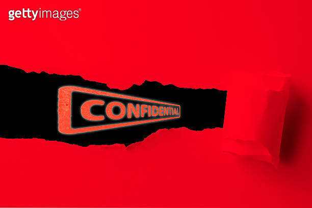 Red text CONFIDENTIAL looked into through the red torn paper (534129797 ...