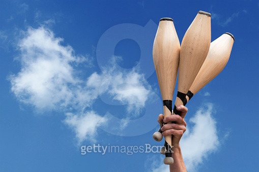 man's hand holding three juggling clubs in the blue sky 이미지 (479015476 ...