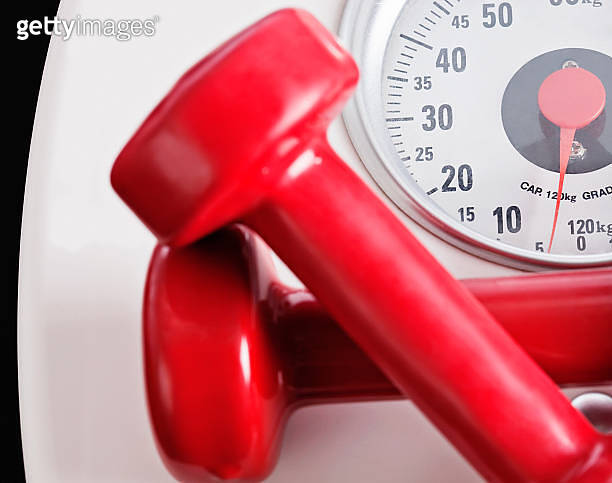 Red weights rest on a domestic scale: weigh-in time 이미지 (471415017 ...