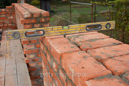 Bricklaying with Spirit Level to Check Brick House Wall Outdoor ...