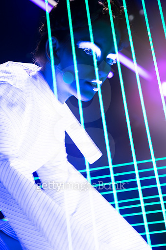 Fashion model beautiful girl in fashionable clothes in ultraviolet ...