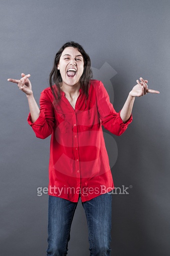 tipsy young woman shouting and dancing with ecstatic body language ...