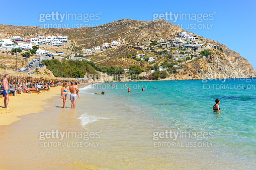 Beachgoers enjoy beautiful beach and tropical sea - Mykonos, Greece 이미지 ...