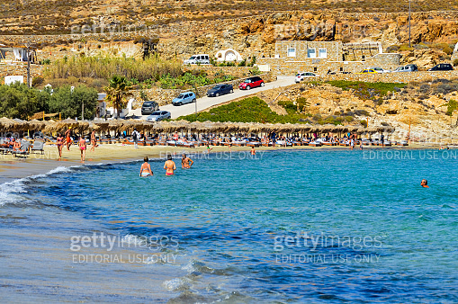 Beachgoers enjoy beautiful beach and tropical sea - Mykonos, Greece ...