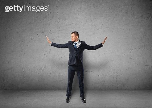 Cutout man pushing invisible walls. Faith in his own strength ...