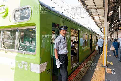 Japanese JR Train Conductor Stands on Platform Before Departure Time ...