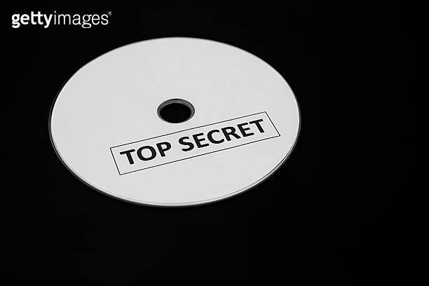 compact disc with label of top secret on black background (511469612 ...