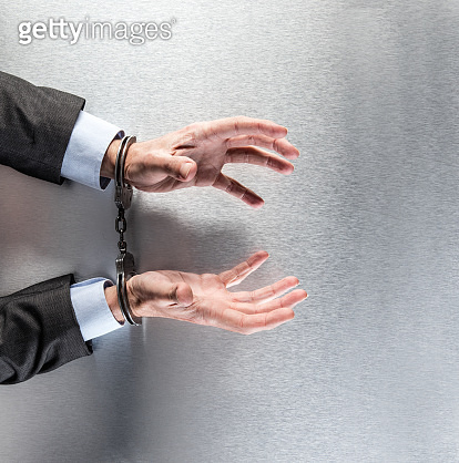 desperate businessman with handcuffs begging and complaining at the ...