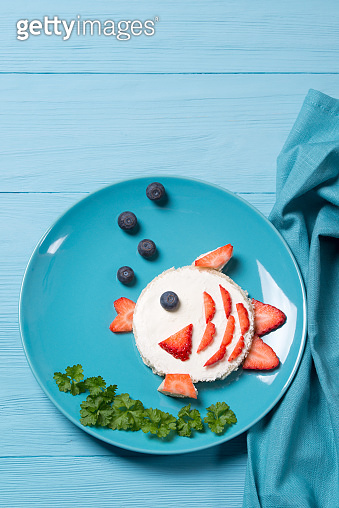 Funny toast in a shape of fish, sandwich with cream cheese and berries ...