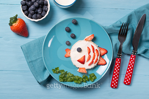 Funny toast in a shape of fish, sandwich with cream cheese and berries ...