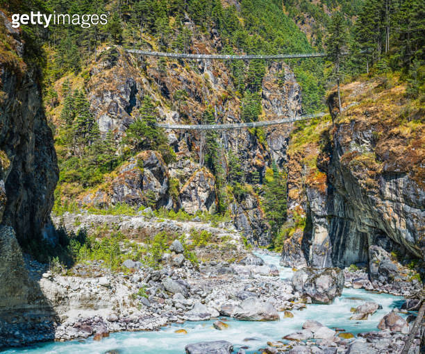 Rope bridges over mountain river canyon Everest trek Himalayas Nepal ...