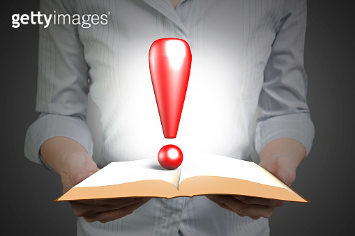 Hands holding opened book with exclamation point 이미지 (663226872) - 게티이미지뱅크