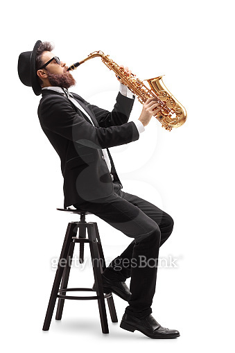Jazz musician seated on a chair playing a saxophone 이미지 (688948810 ...