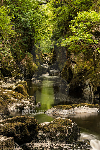 Stunning ethereal landscape of deep sided gorge with rock walls and ...