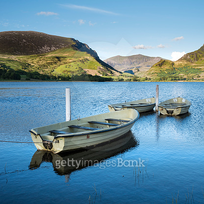 Stunning dramatic stormy sky formations over breathtaking mountain lake ...