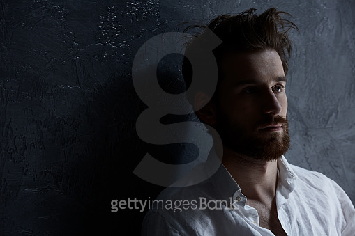 Sad man standing against wall 이미지 (650327252) - 게티이미지뱅크