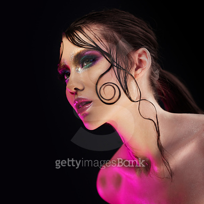 Young beautiful girl bright makeup with a wet look shine, dark ...