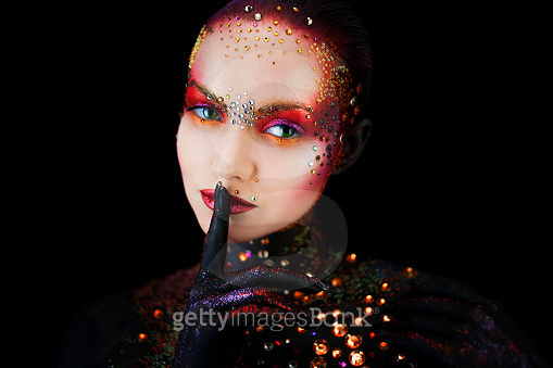 Young attractive girl in bright art-makeup, body painting. Touching ...