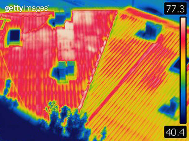 Thermal image of very hot summer day. Tin house roof, high angle view ...