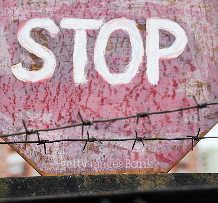 Stop sign behind the barbed wire 이미지 (627371536) - 게티이미지뱅크